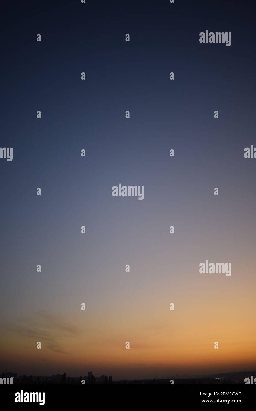 Beautiful bright sunset with multicolored evening glowing over skyline ...