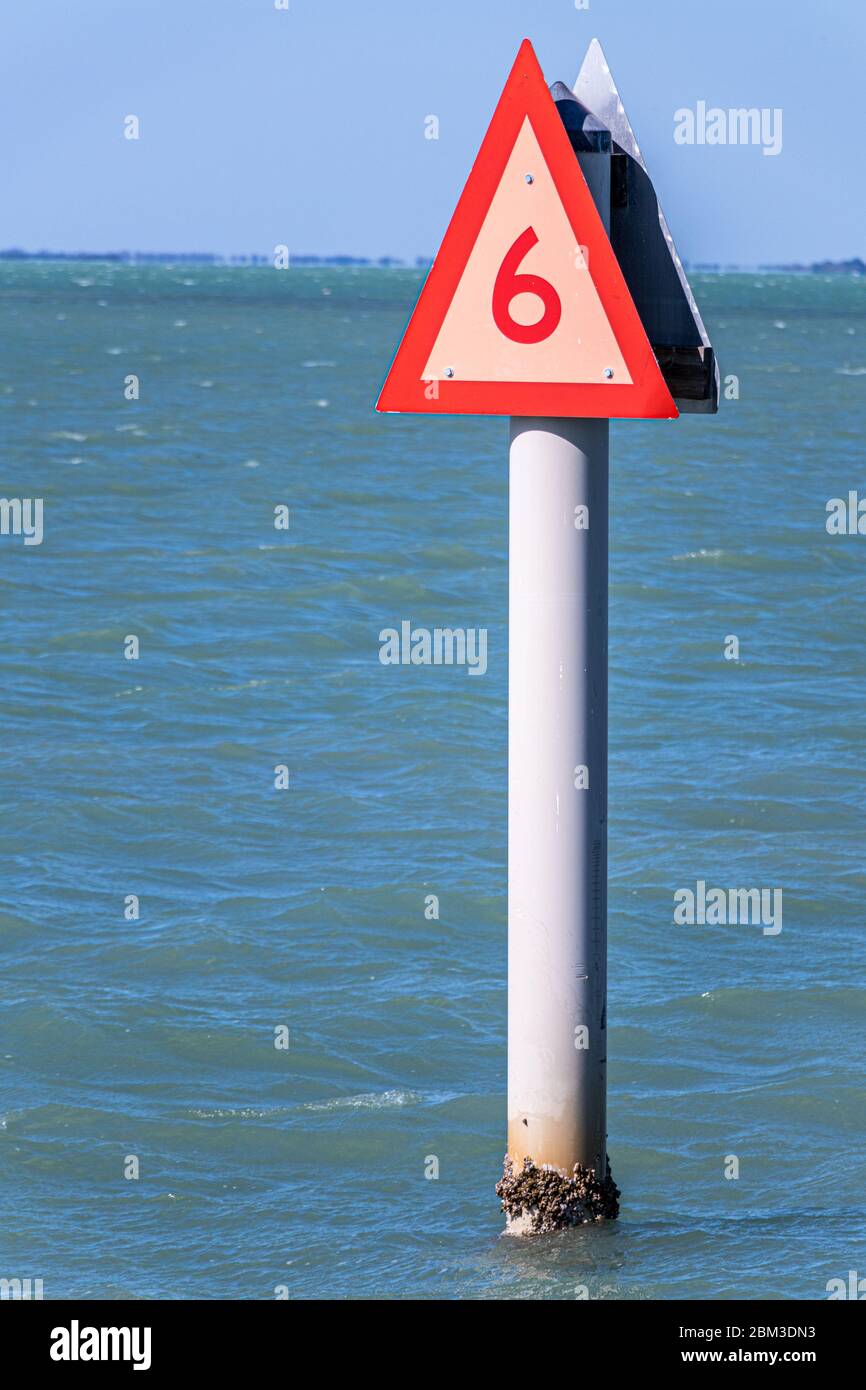 Trianglular sign in open ocean Stock Photo - Alamy