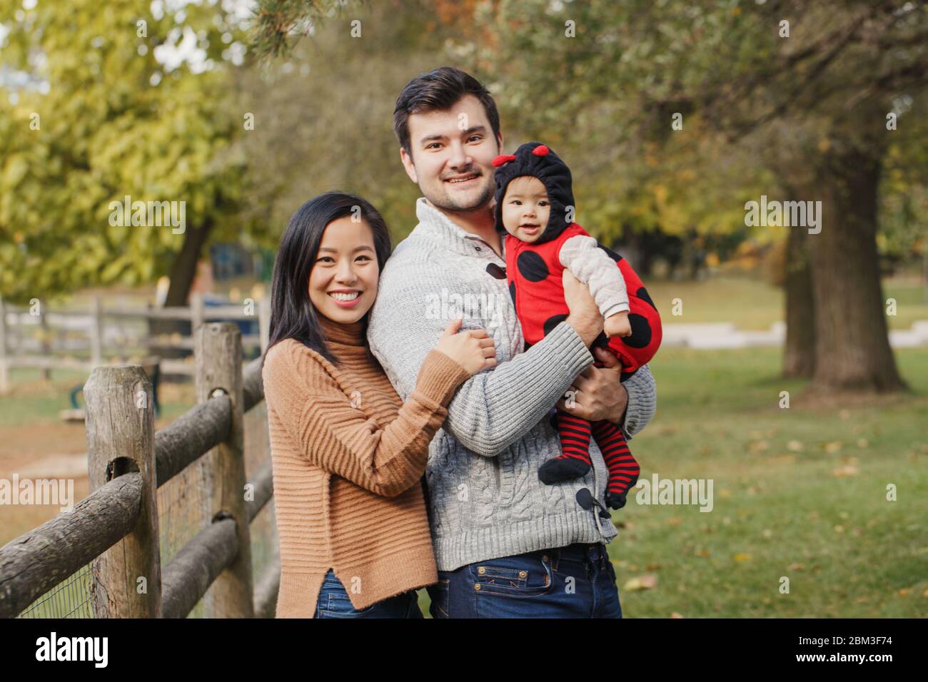 Happy smiling Asian Chinese mother and Caucasian father dad with baby ...