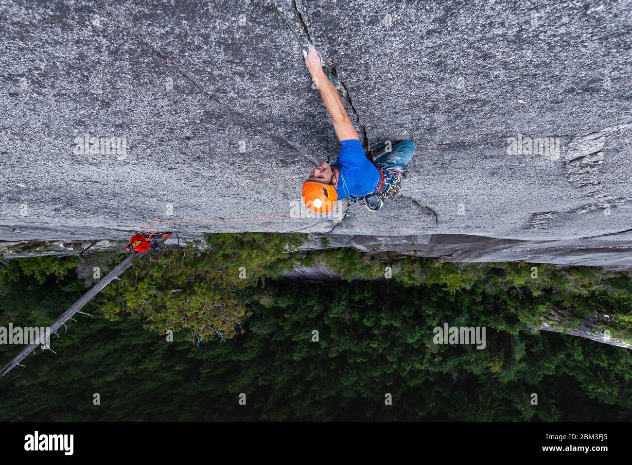 Man crack rock climbing in Squamish view from top exposed multipitch ...