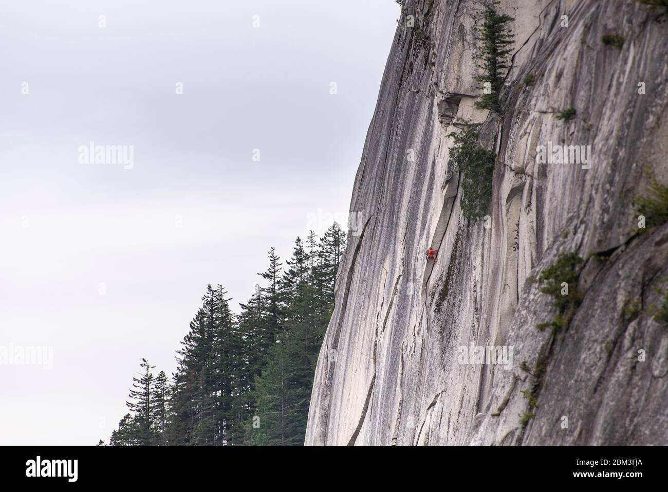Man rock climbing a multipitch trad route on the Chief Squamish Stock ...