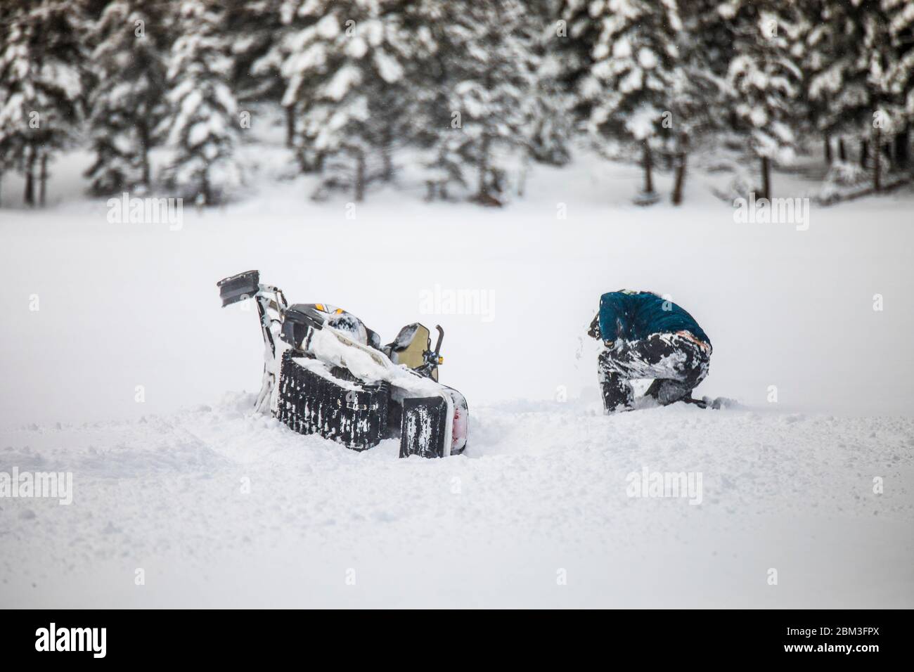 Snowmobiler crashes his sled during failed high-speed stunt Stock Photo ...