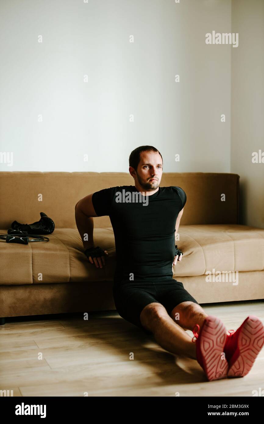 young muscular guy working out at home. young muscular Athletic man ...