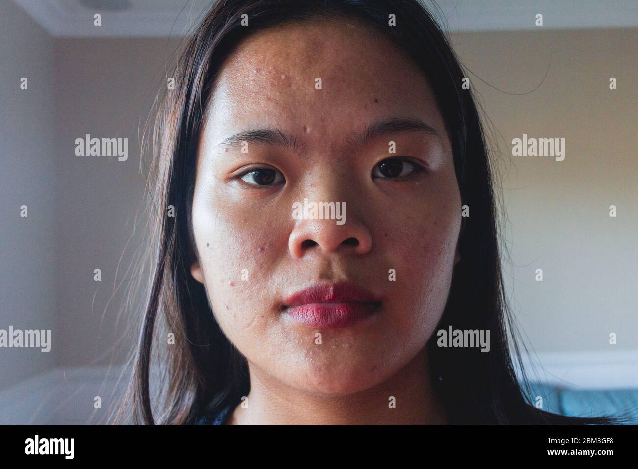 Sad asian face looking at camera Stock Photo - Alamy