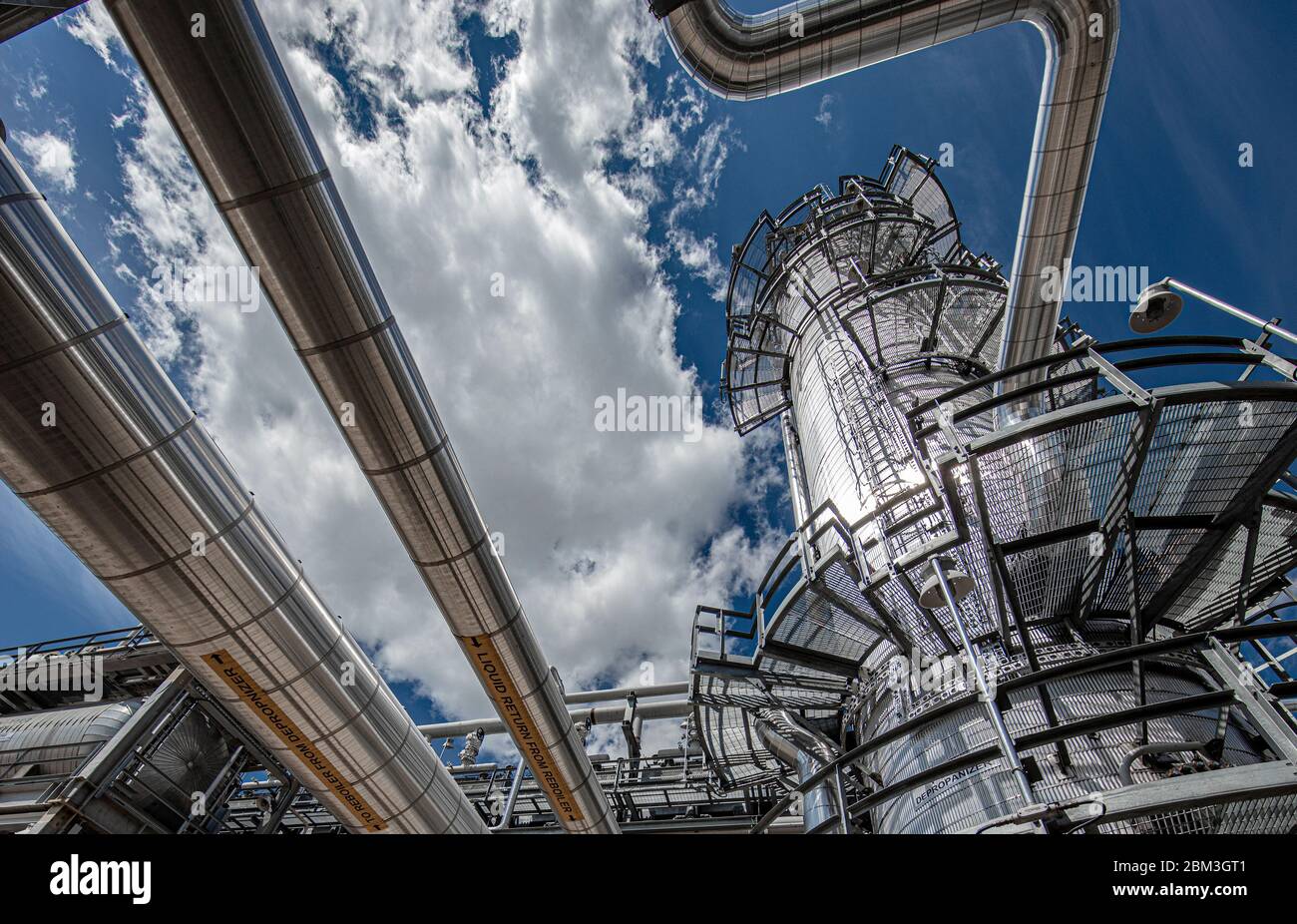 Natural gas processing plant structures with sun flare Stock Photo - Alamy