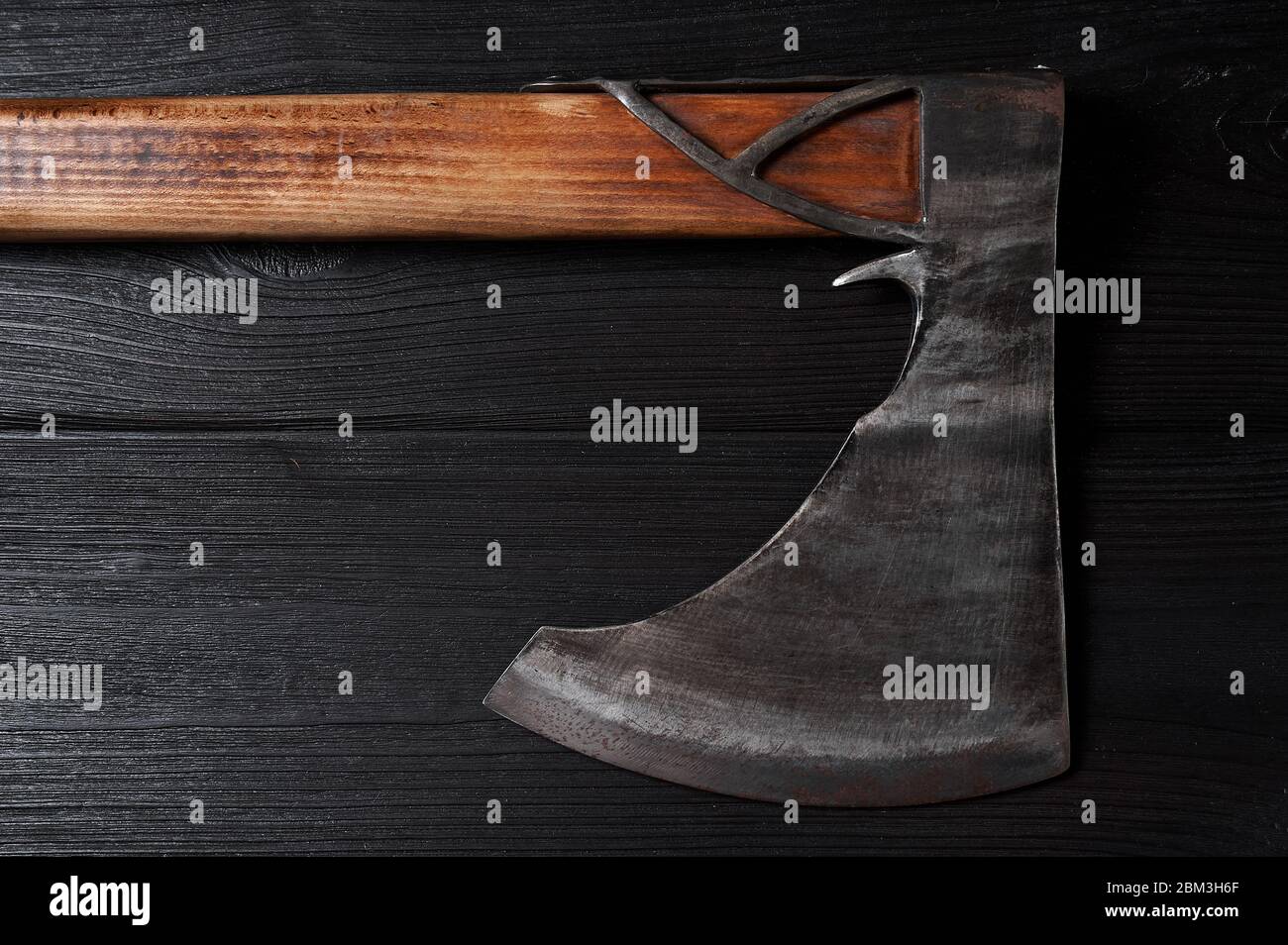 real scandinavian ax on a black wooden background, still life, viking ...