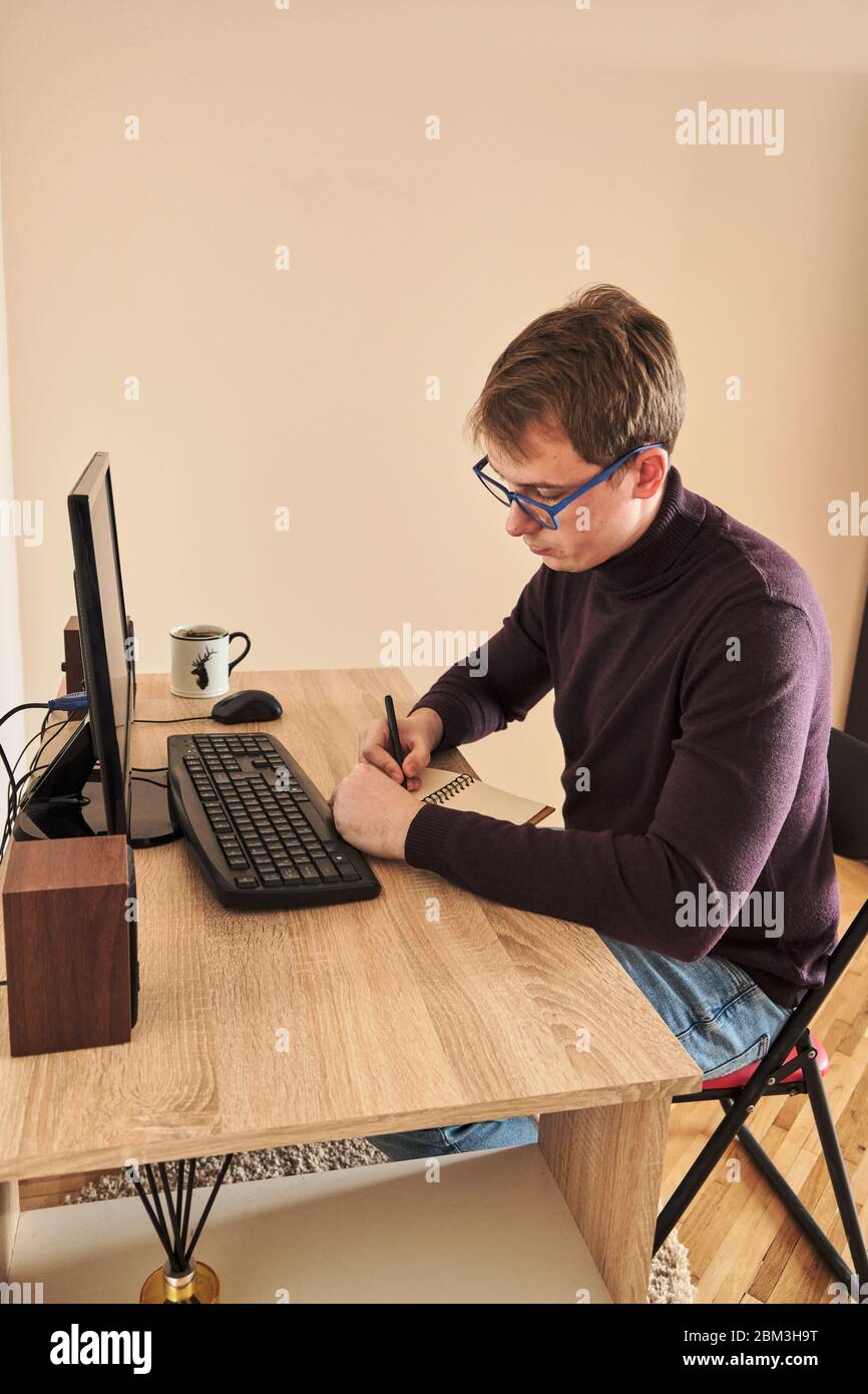 Smiling man working on computer at desk in office Stock Photo - Alamy