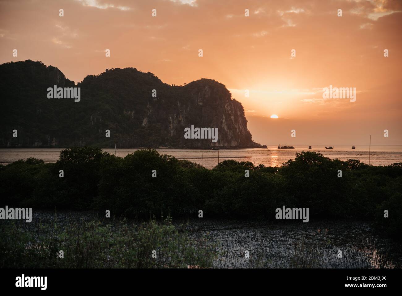 Stunning sunset over Ha Long Bay viewed from Cat Ba Island, Vietnam ...