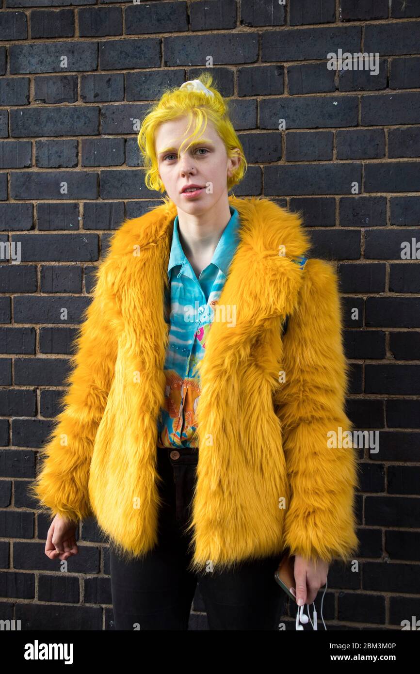 Barcelona, Spain - 13 February, 2020, A girl with yellow hair in a faux ...