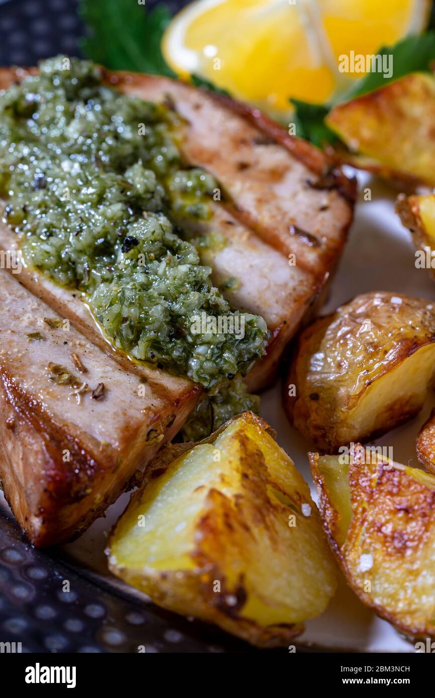 Roasted fish with baked potato wedges hi-res stock photography and ...