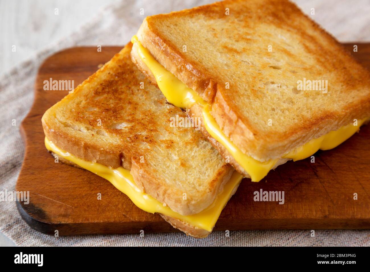 Homemade Grilled Cheese Sandwich on a rustic wooden board, side view ...