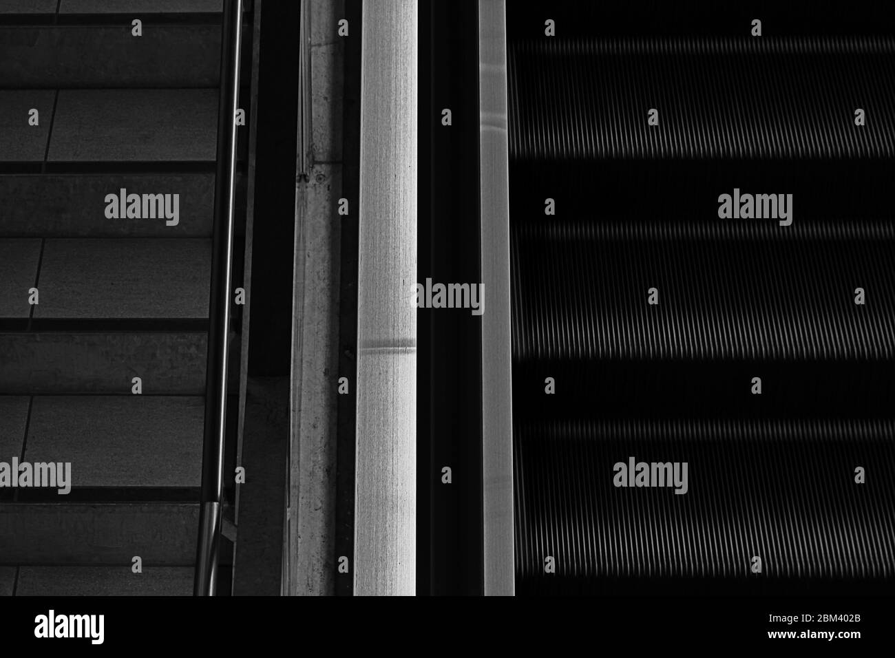 An abstract photo taken from the top of a row of escalators and stairs ...