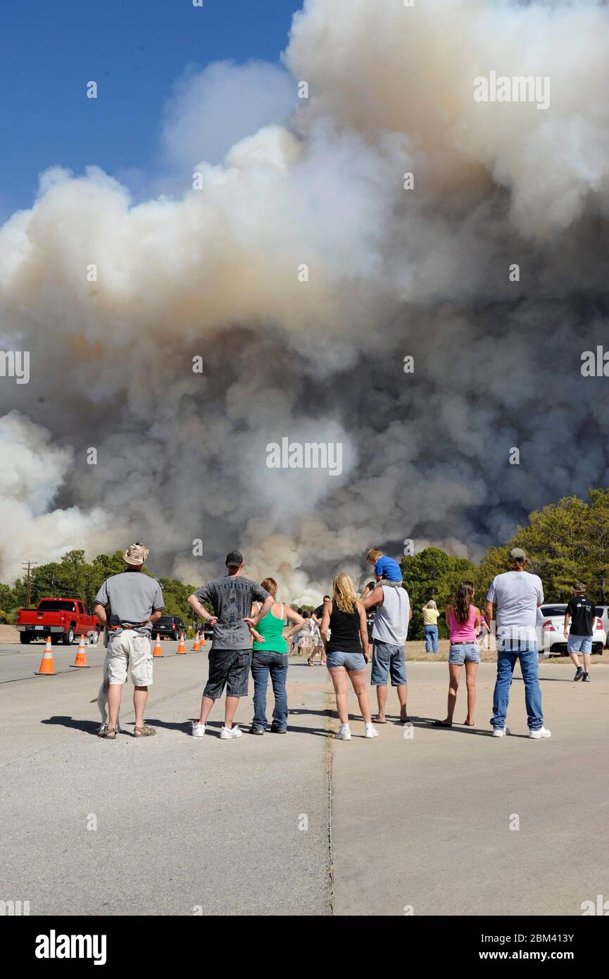 Bastrop, Texas USA, September 5, 2011: Onlookers watch smoke from a ...