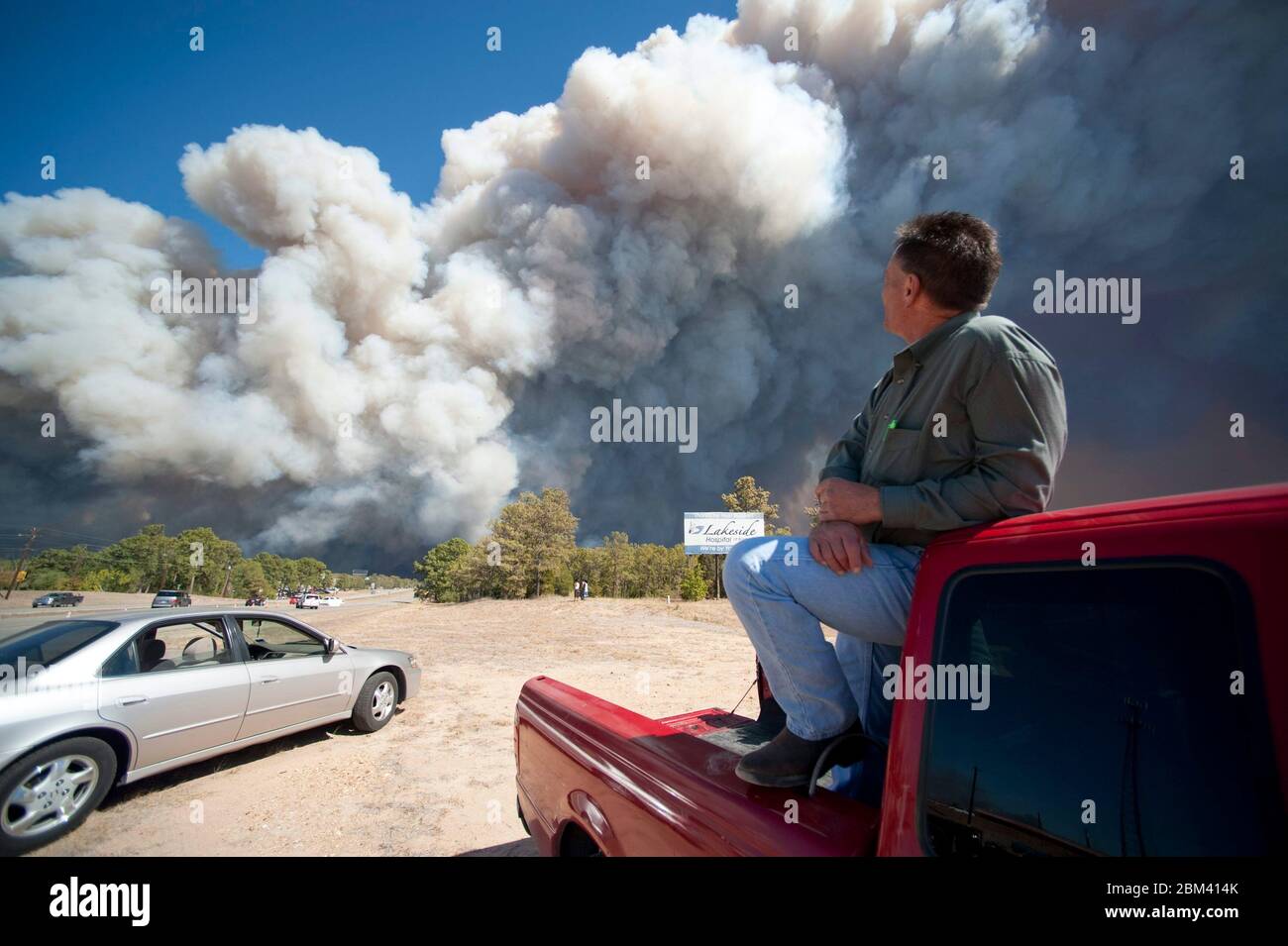 Bastrop, Texas USA, September 5, 2011: A resident watches heavy smoke ...
