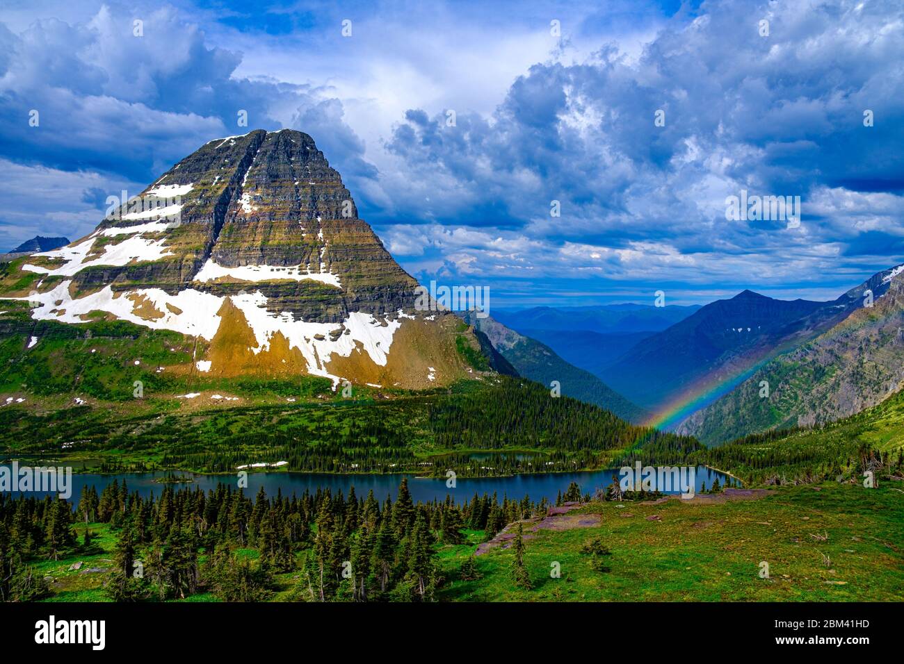 2403 A rainbow forms as sunlight hits the mountain after the storm ...