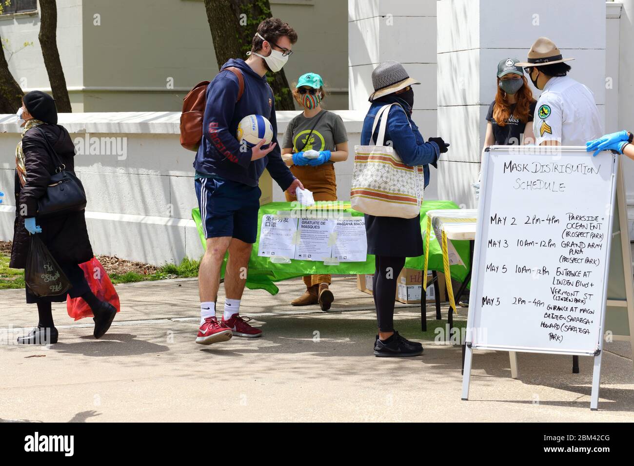 NYC Parks Department personnel distribute free cloth face masks to ...