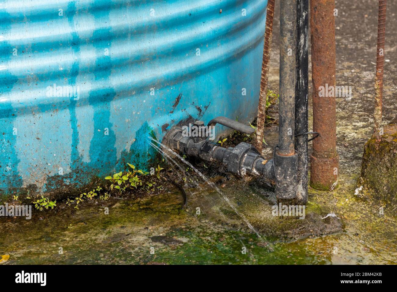 Water leakage from crack in water tank installed in house rooftop Stock ...