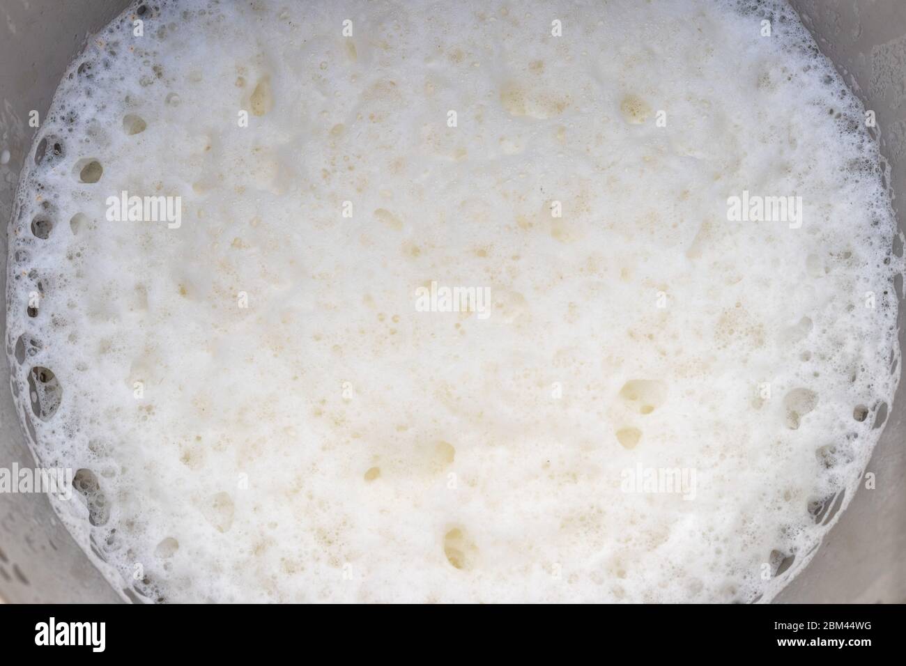 Fresh cow milk with foam, close-up top view Stock Photo - Alamy