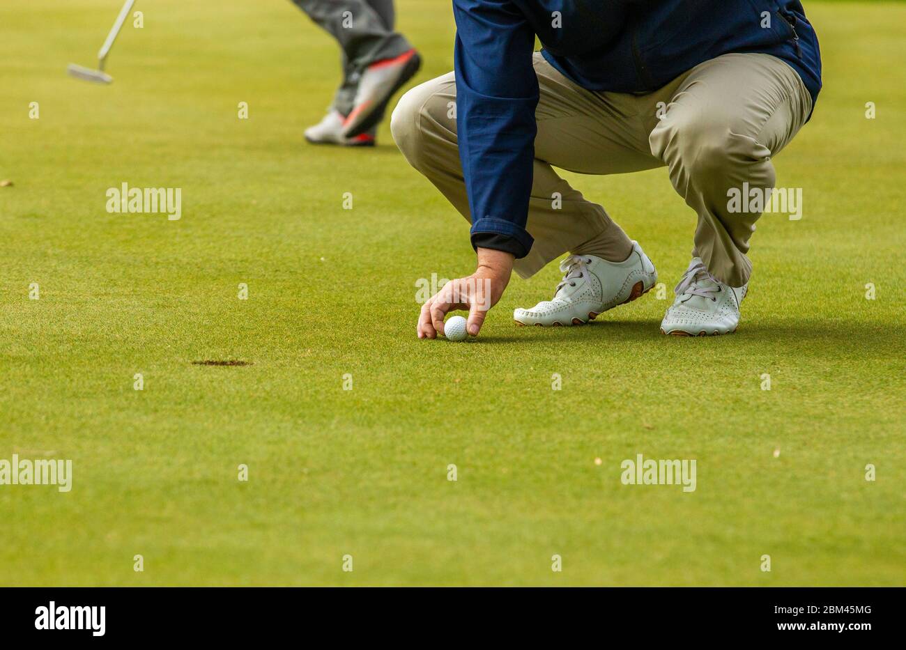 Player a during a golf game during a hit Stock Photo - Alamy