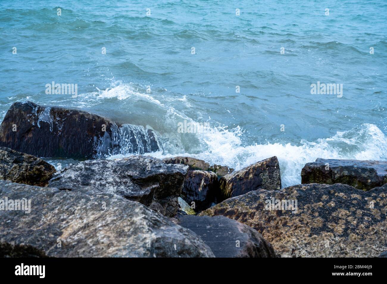 Water Splashing on Large Rocks Stock Photo - Alamy