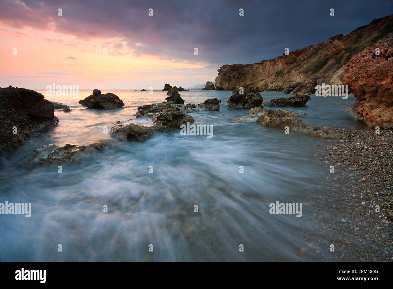 Sunset on a beach in Crete, Greece Stock Photo - Alamy