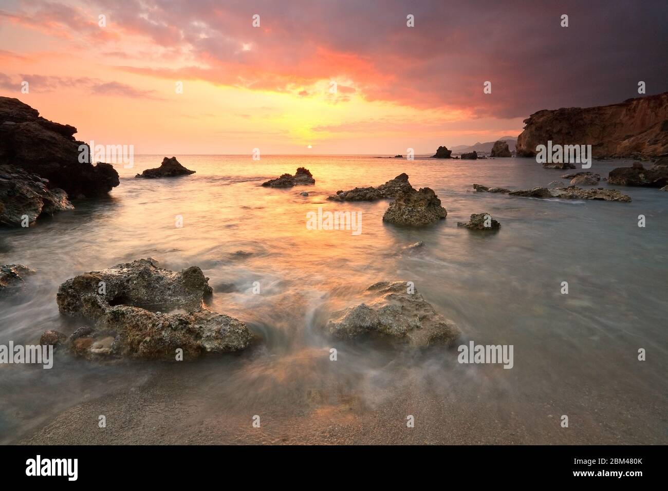Sunset on a beach in Crete, Greece Stock Photo - Alamy