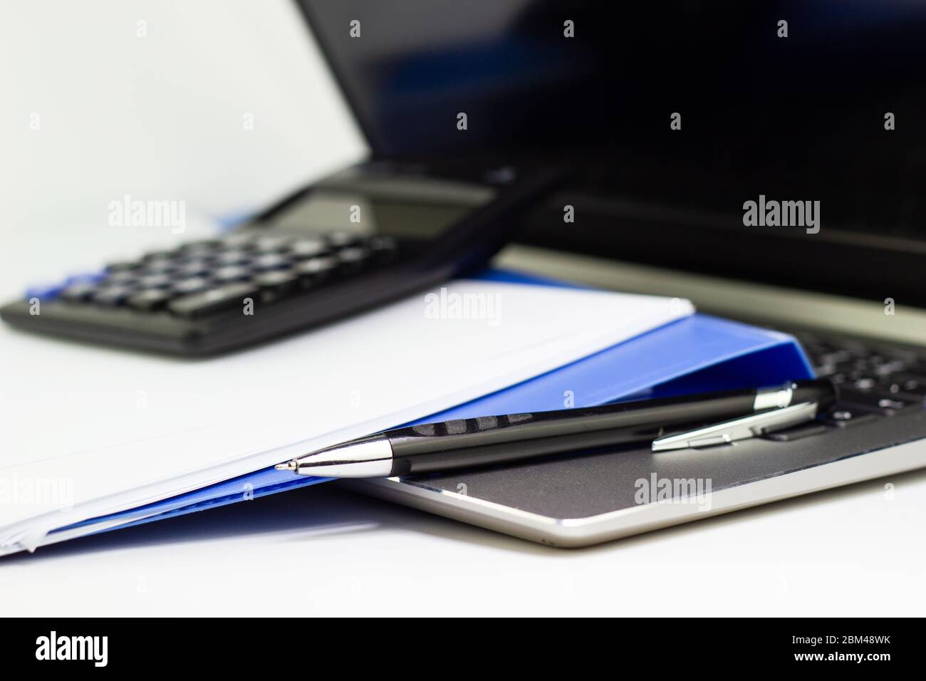 Close Up Blue file folder and Laptop Computer on desk in meeting room ...
