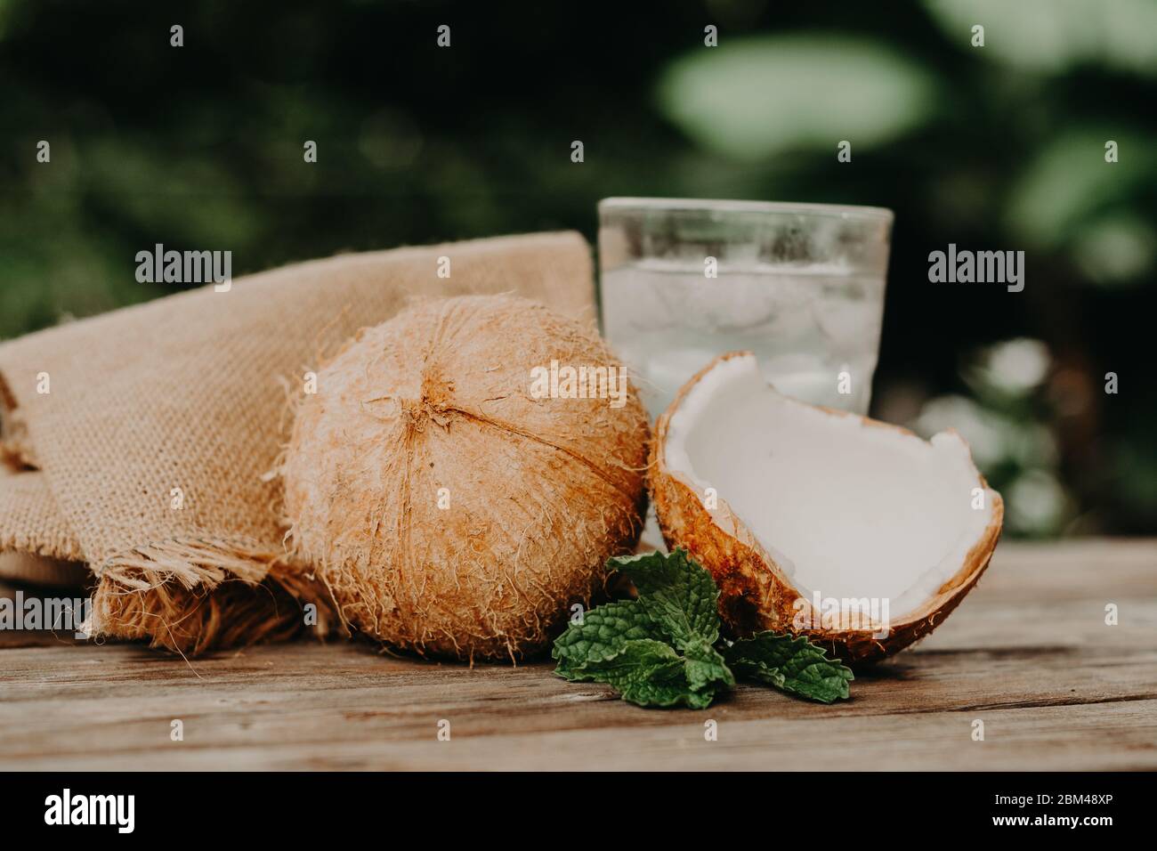 Coconut water. Fresh and delicious coconut water. wood and green ...