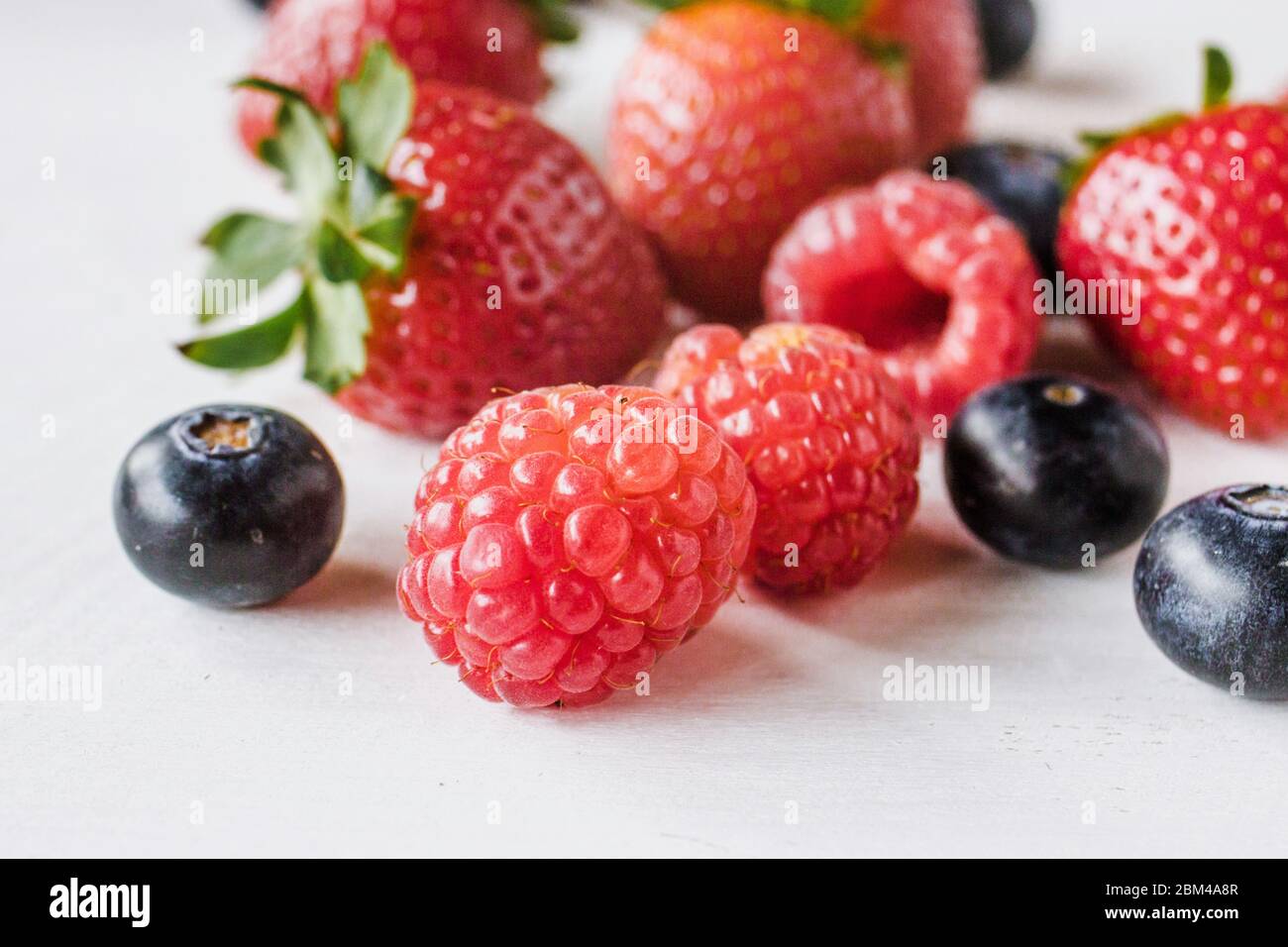 Strawberry, raspberry, blueberry and blackberry on white background ...