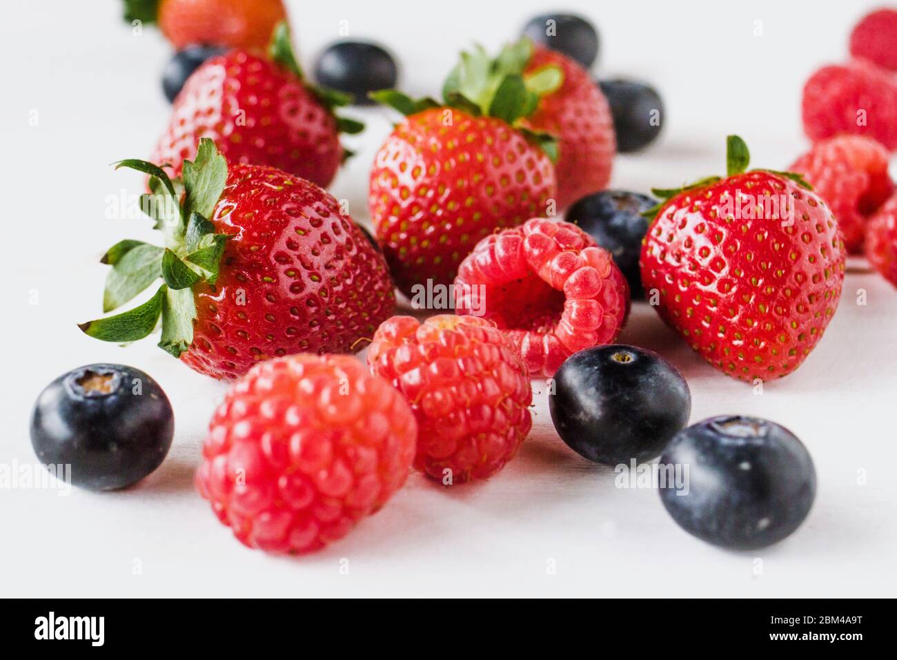 Strawberry, raspberry, blueberry and blackberry on white background ...