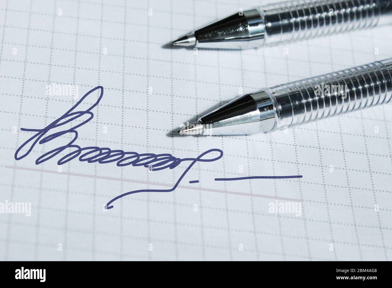 Signature and ballpoint pen on a sheet of white paper Stock Photo - Alamy