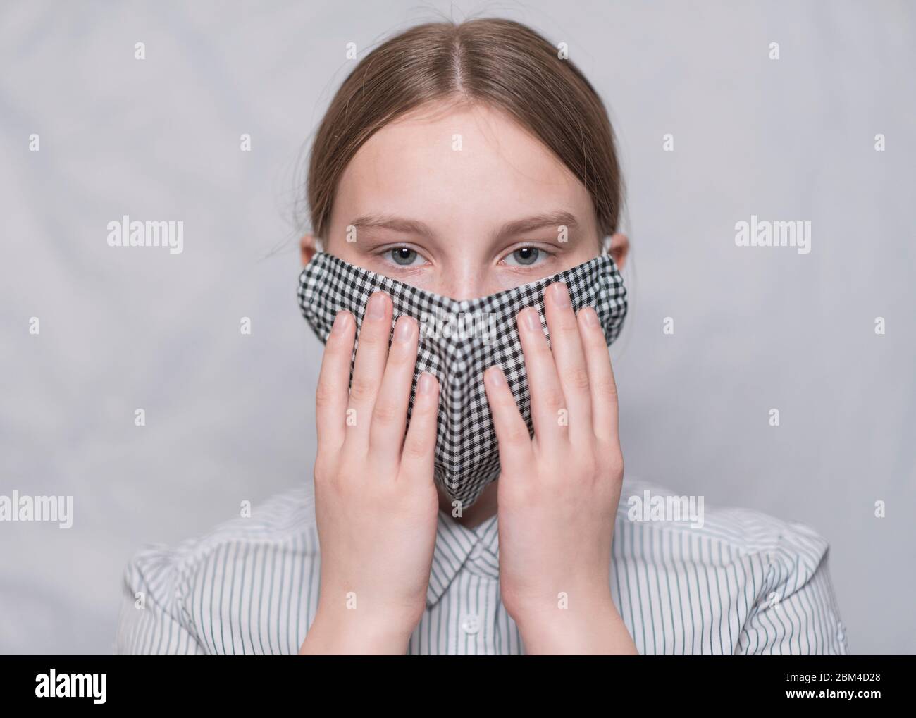 Close-up portrait, teenage girl of 15 years old, mask, holds mask with ...