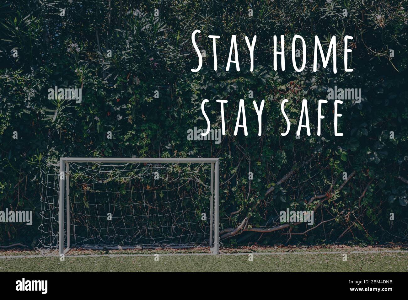 Soccer goal at the outdoor amateur field surrounded by green plant wall ...