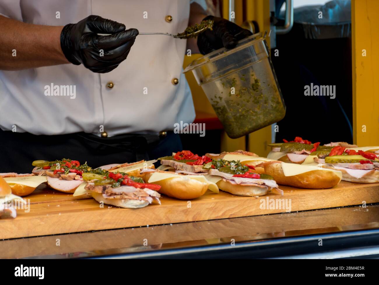 Chef preparing subway sandwich, live cooking session. Fast food ...