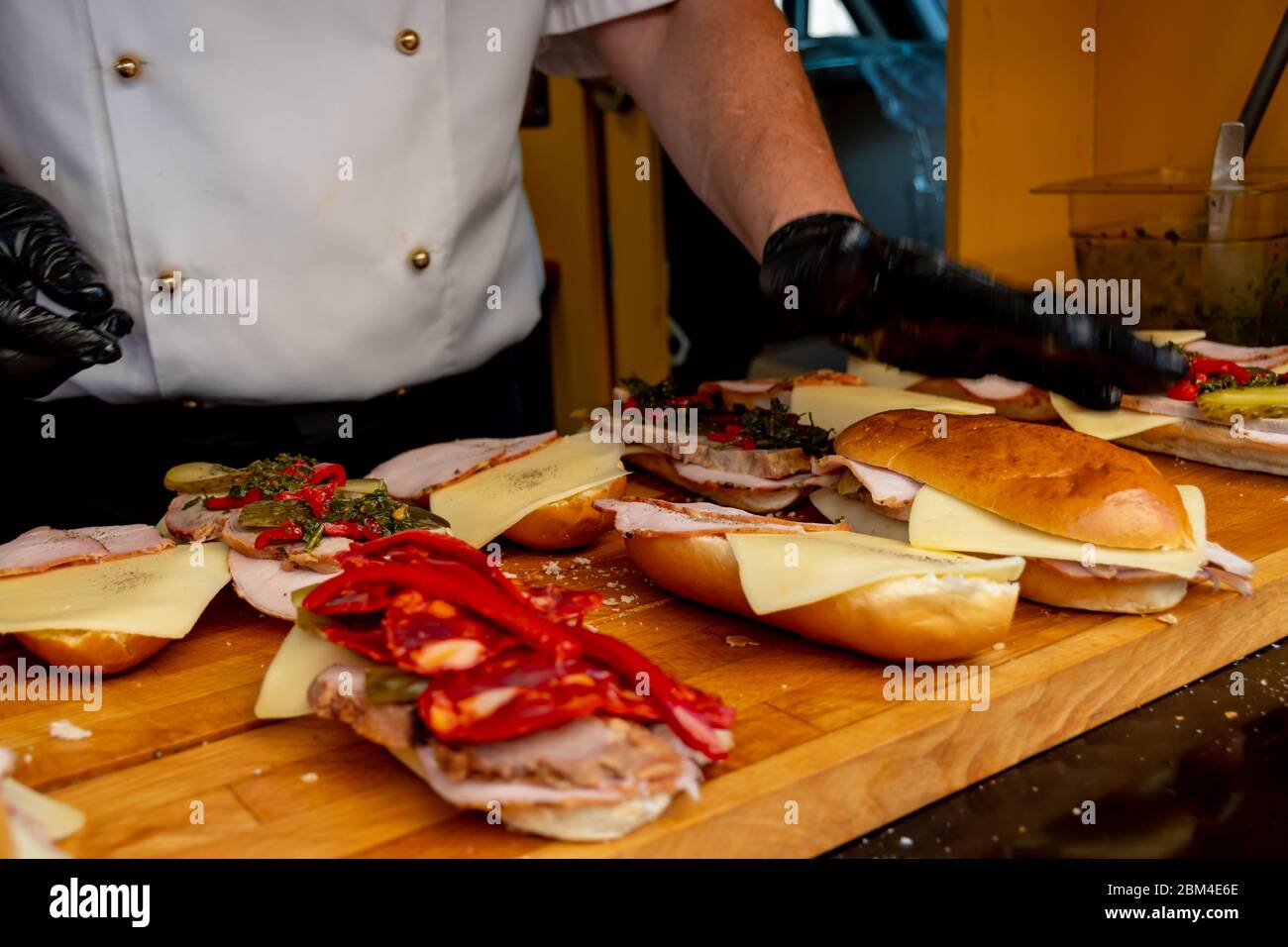 Chef preparing subway sandwich, live cooking session. Fast food ...