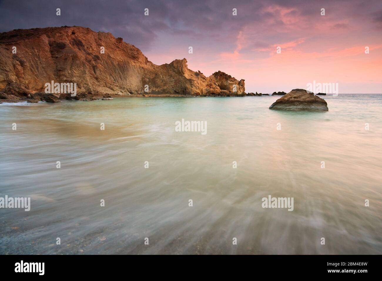 Sunset on a beach in Crete, Greece Stock Photo - Alamy