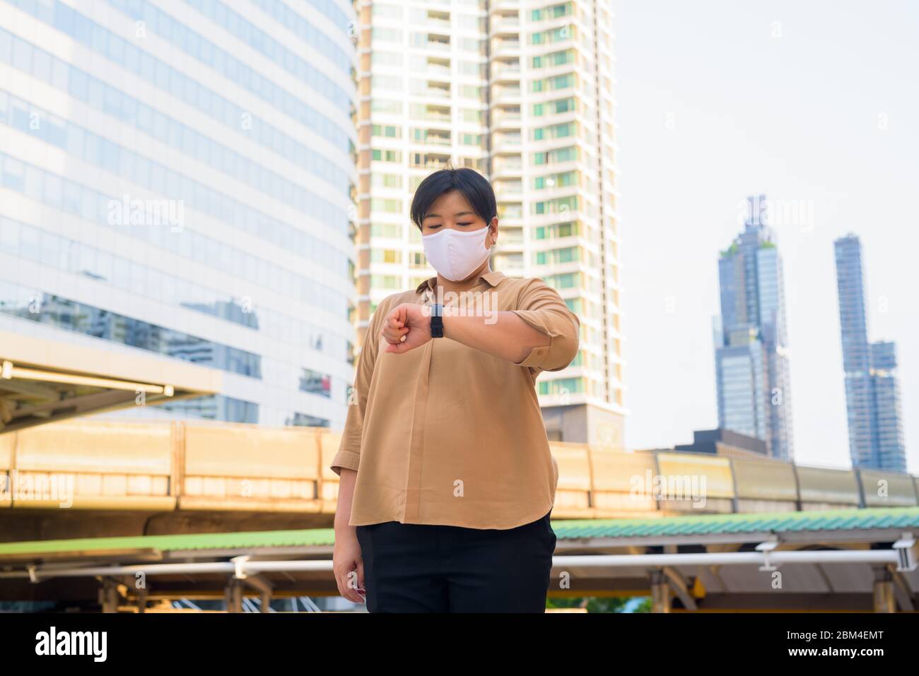 Fat woman checking time hi-res stock photography and images - Alamy