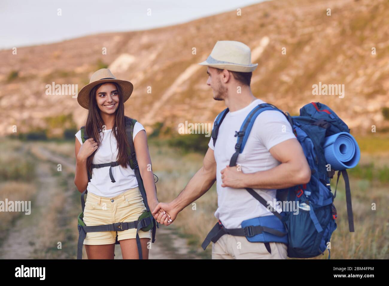 Happy hiking couple with backpack walking on hike in nature.Backpacker camping traveler trip ...