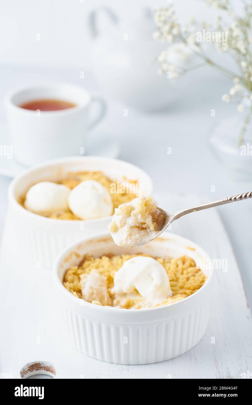 Apple crumble, spoon with ice cream, streusel. Side view, vertical ...
