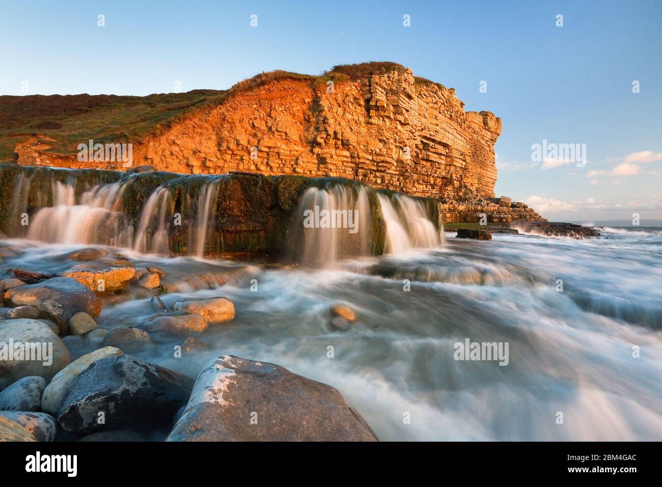 Waterfall on Monknash beach in Glamorgan, Wales, UK Stock Photo - Alamy