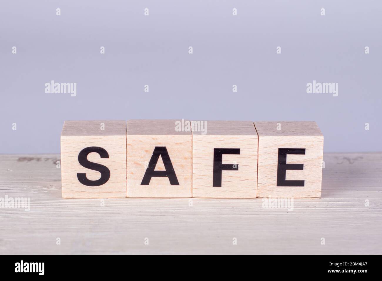 wooden cubes building the word Safe, white background and board Stock ...