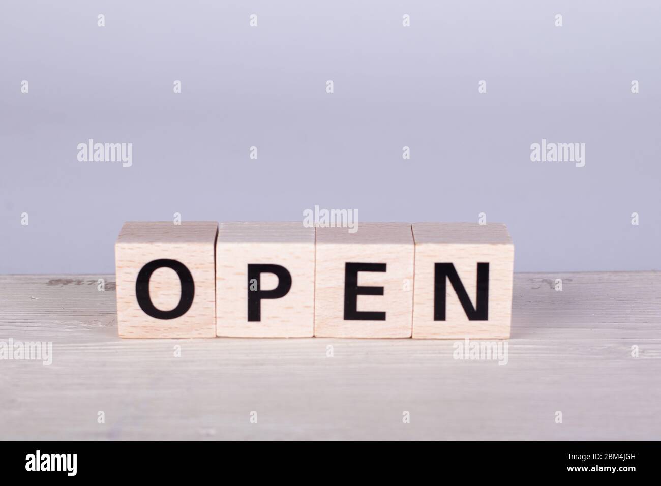 wooden cubes building the word Open, white background and board Stock ...