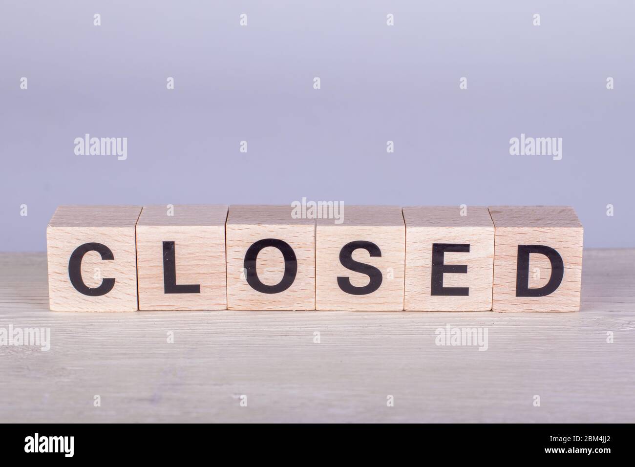 wooden cubes building the word Closed, white background and board Stock ...