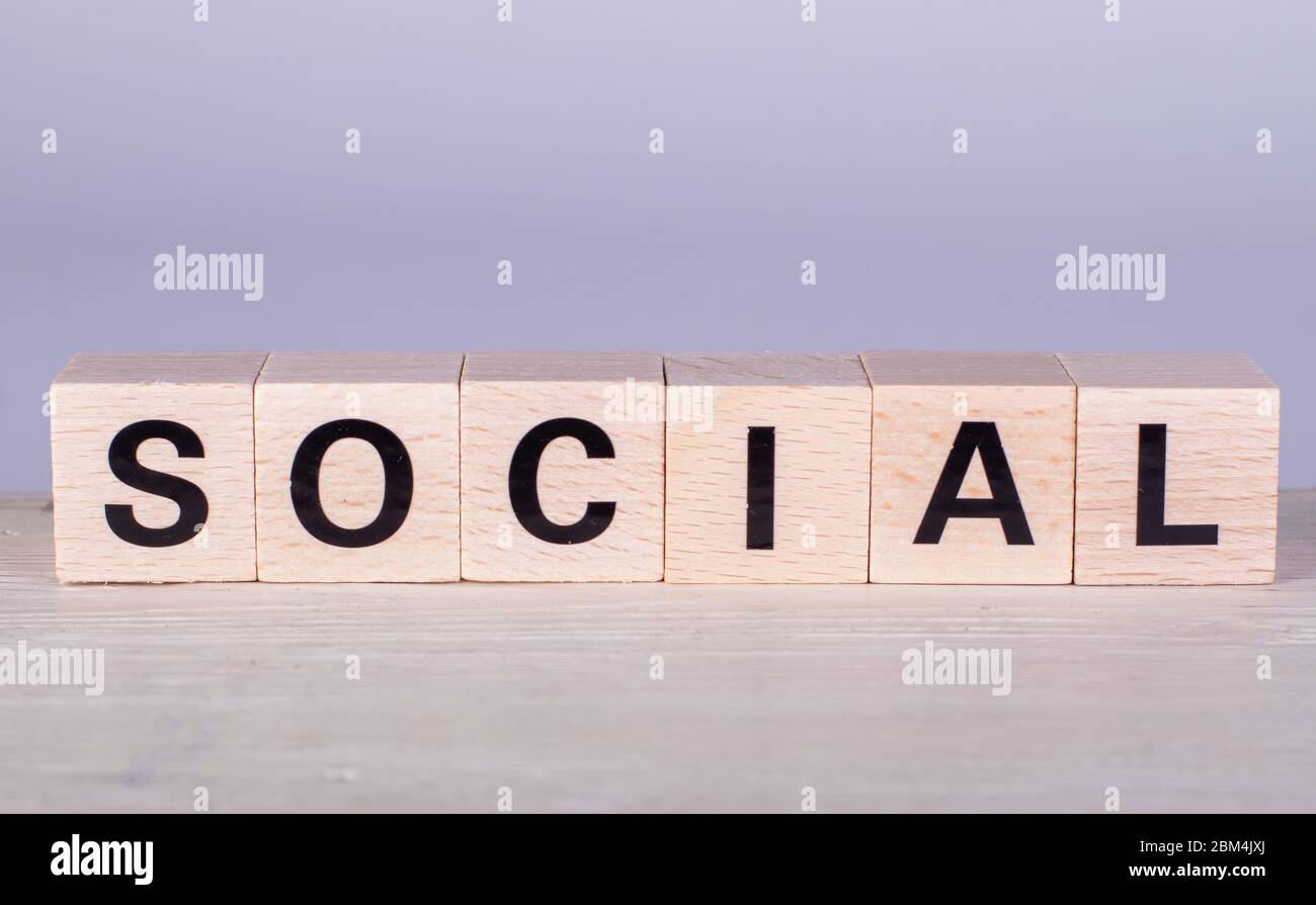 wooden cubes building the word Social, white background and board Stock ...