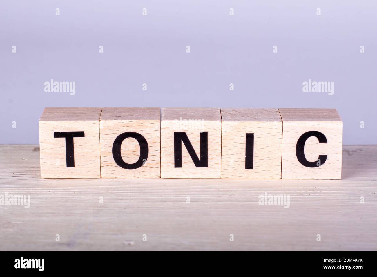 wooden cubes building the word Tonic, white background and board Stock ...