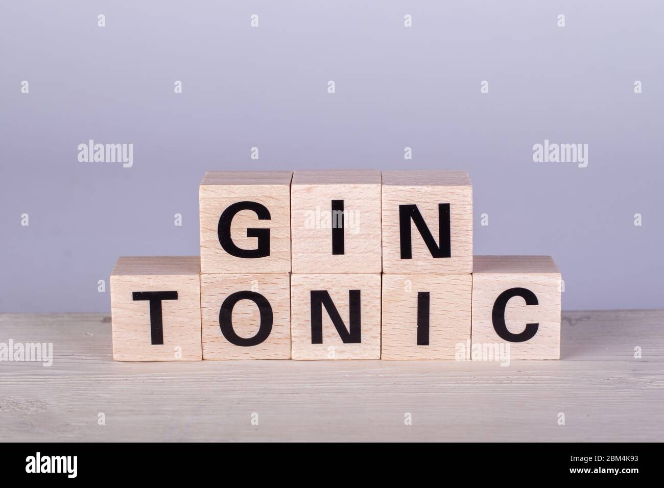 wooden cubes building the word Gin Tonic, white background and board ...