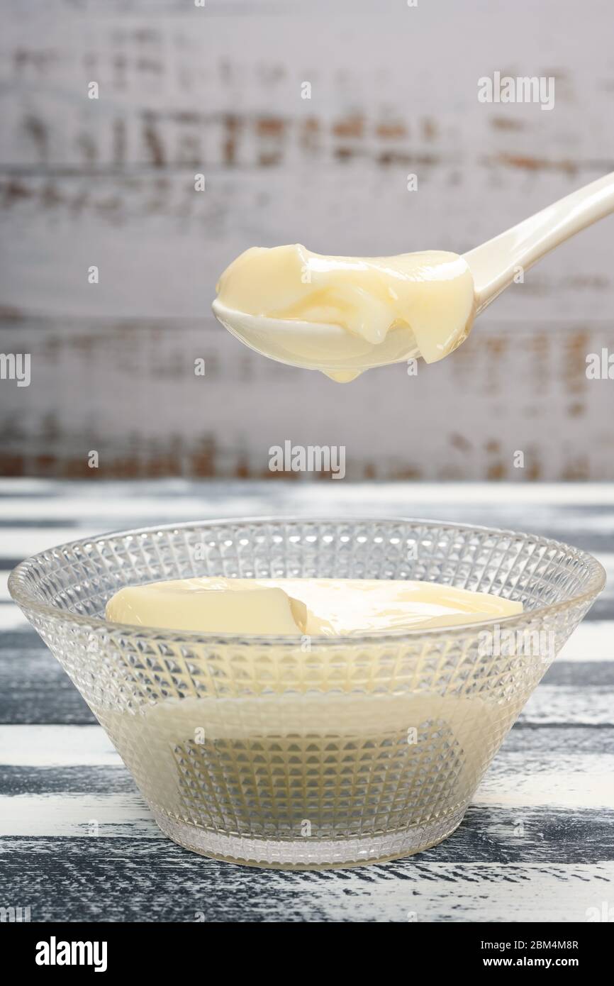 eating fresh milk pudding vertical composition Stock Photo - Alamy
