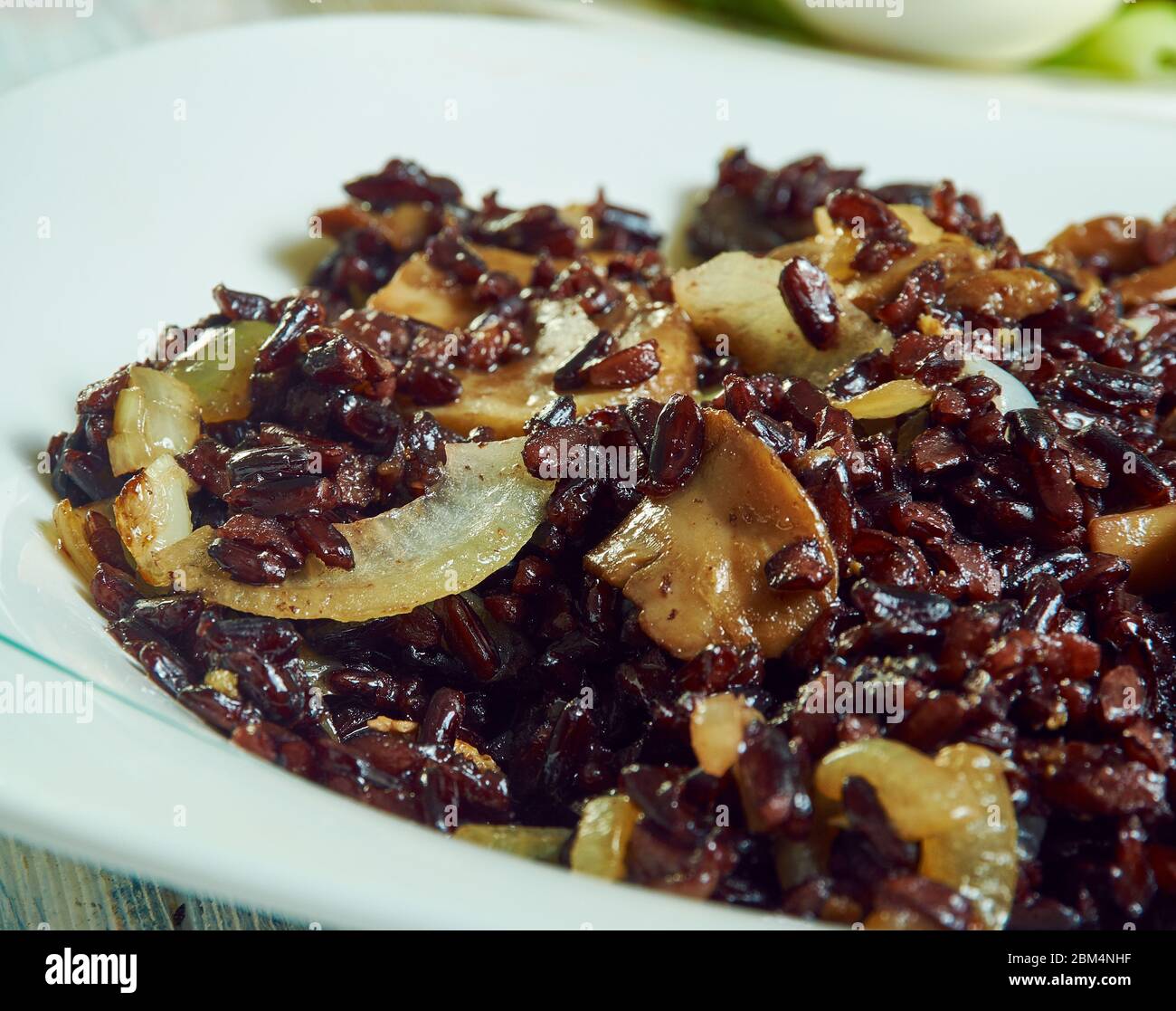 Black Rice Risotto with Mushrooms and Caramelized Onion Stock Photo - Alamy