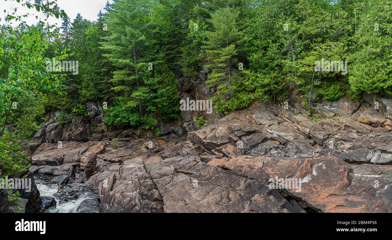 Rocks with green trees background hi-res stock photography and images ...