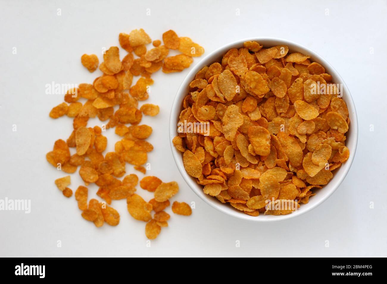 Corn flakes, dry, in a white bowl on a white cardboard surface Stock ...